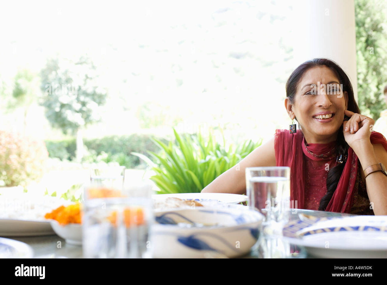 Woman eating table head scarf hi-res stock photography and images - Alamy