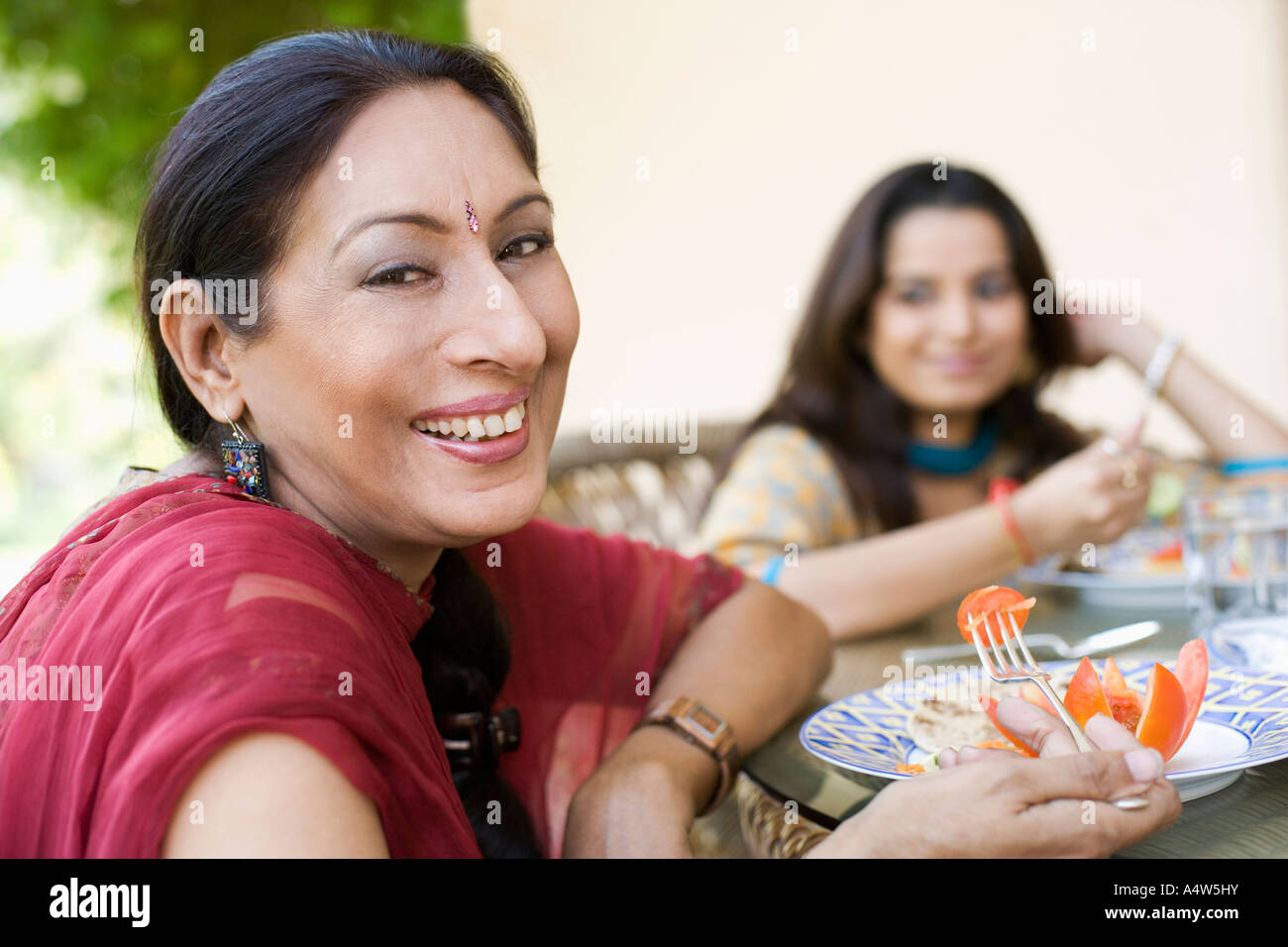 Woman eating table head scarf hi-res stock photography and images - Alamy
