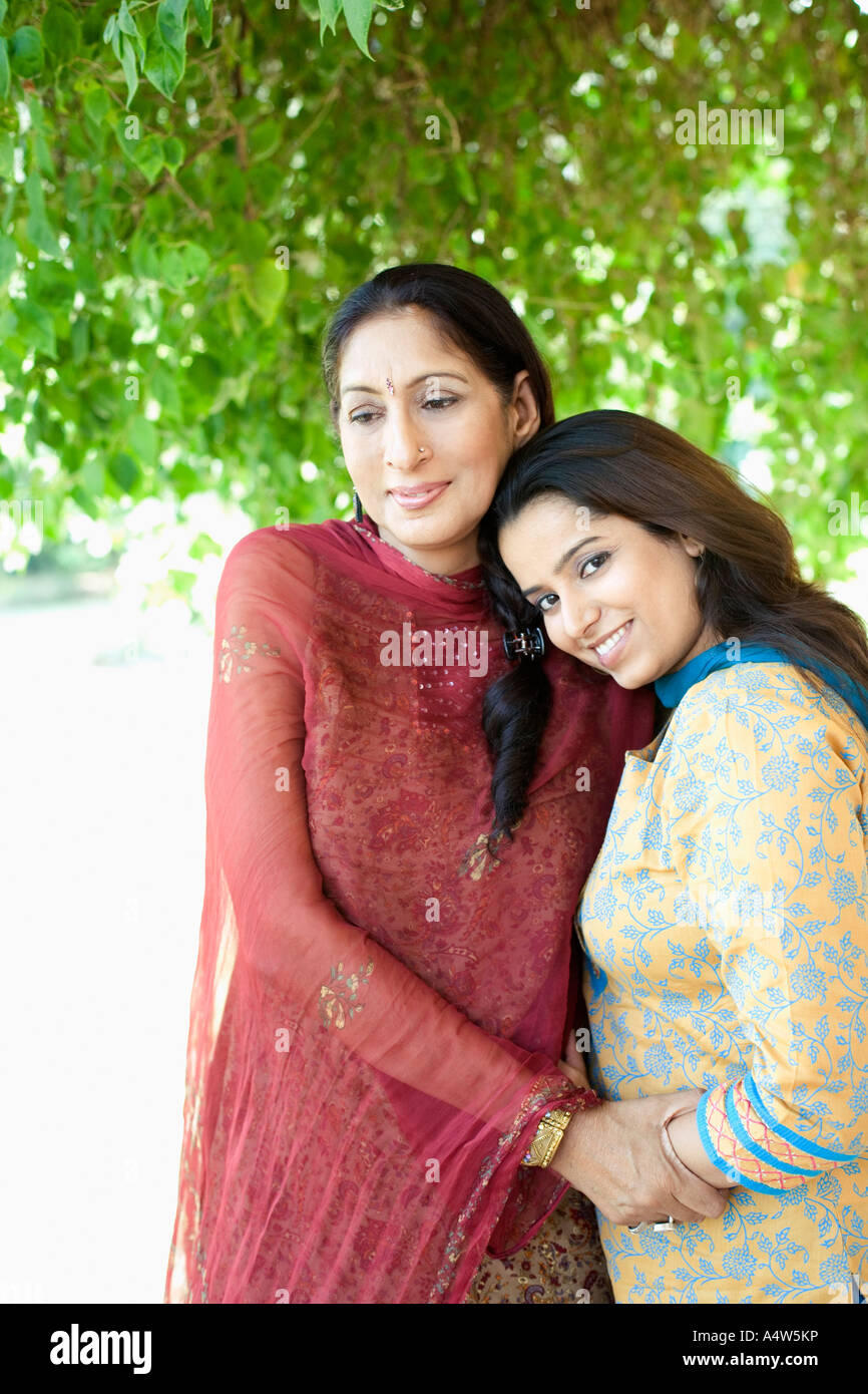 Mother hugging her adult daughter outdoors Stock Photo - Alamy
