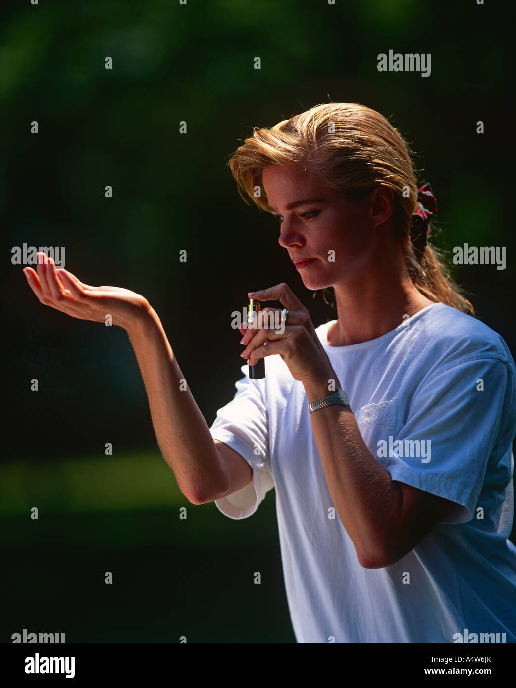 GIRL SPRAYING PERFUME Stock Photo - Alamy