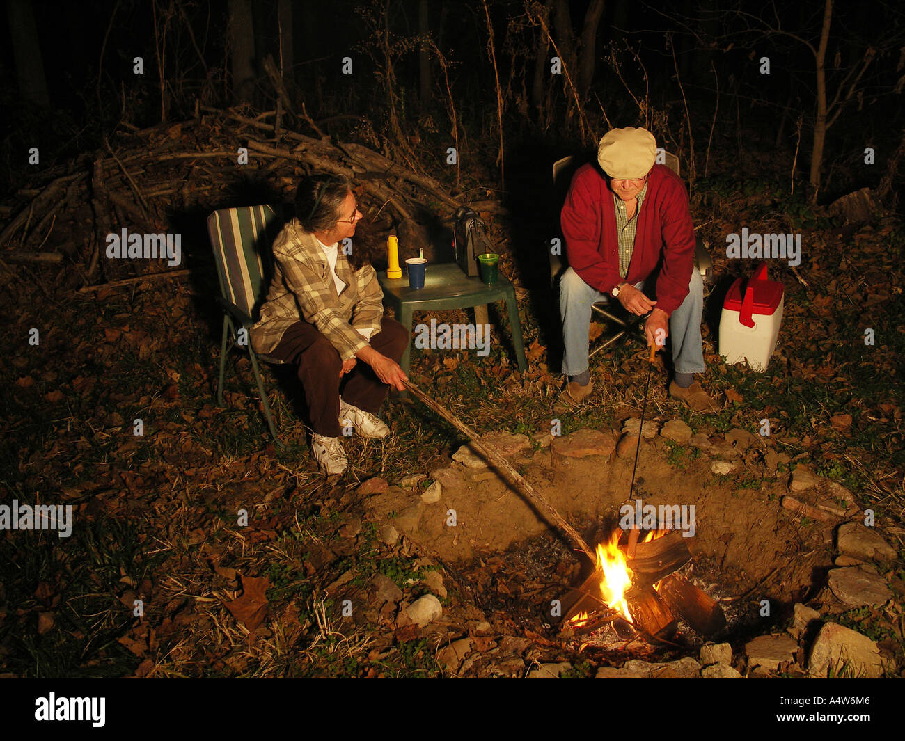 Couple Cooking over Campfire Stock Photo - Alamy