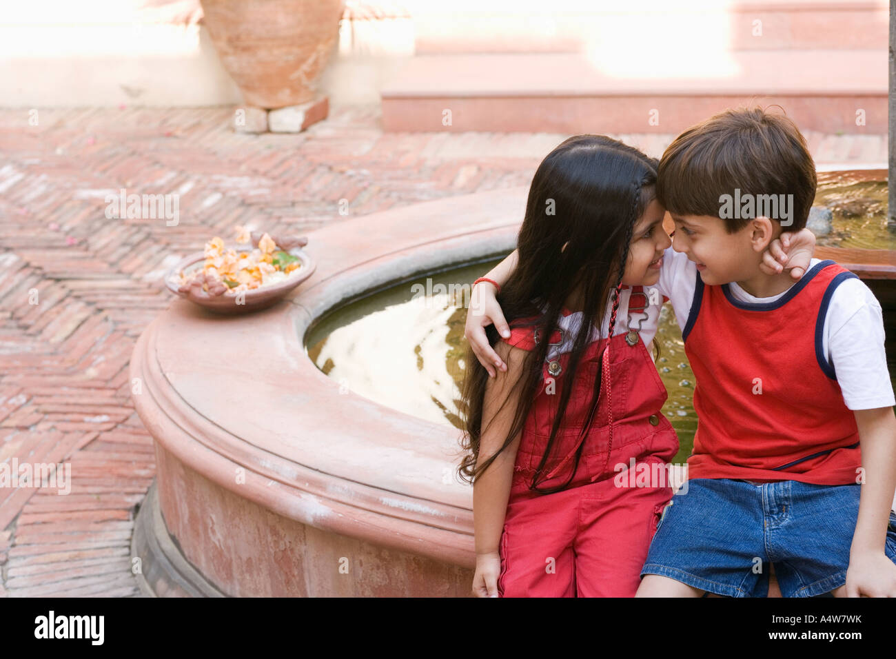 Children hugging by fountain outdoors Stock Photo - Alamy
