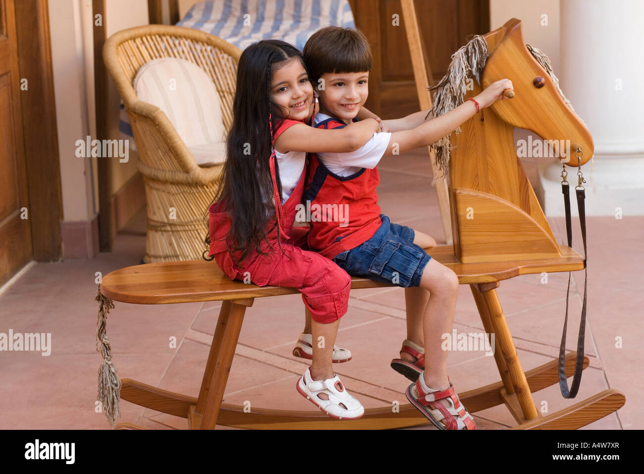 Children playing on wooden rocking horse Stock Photo - Alamy