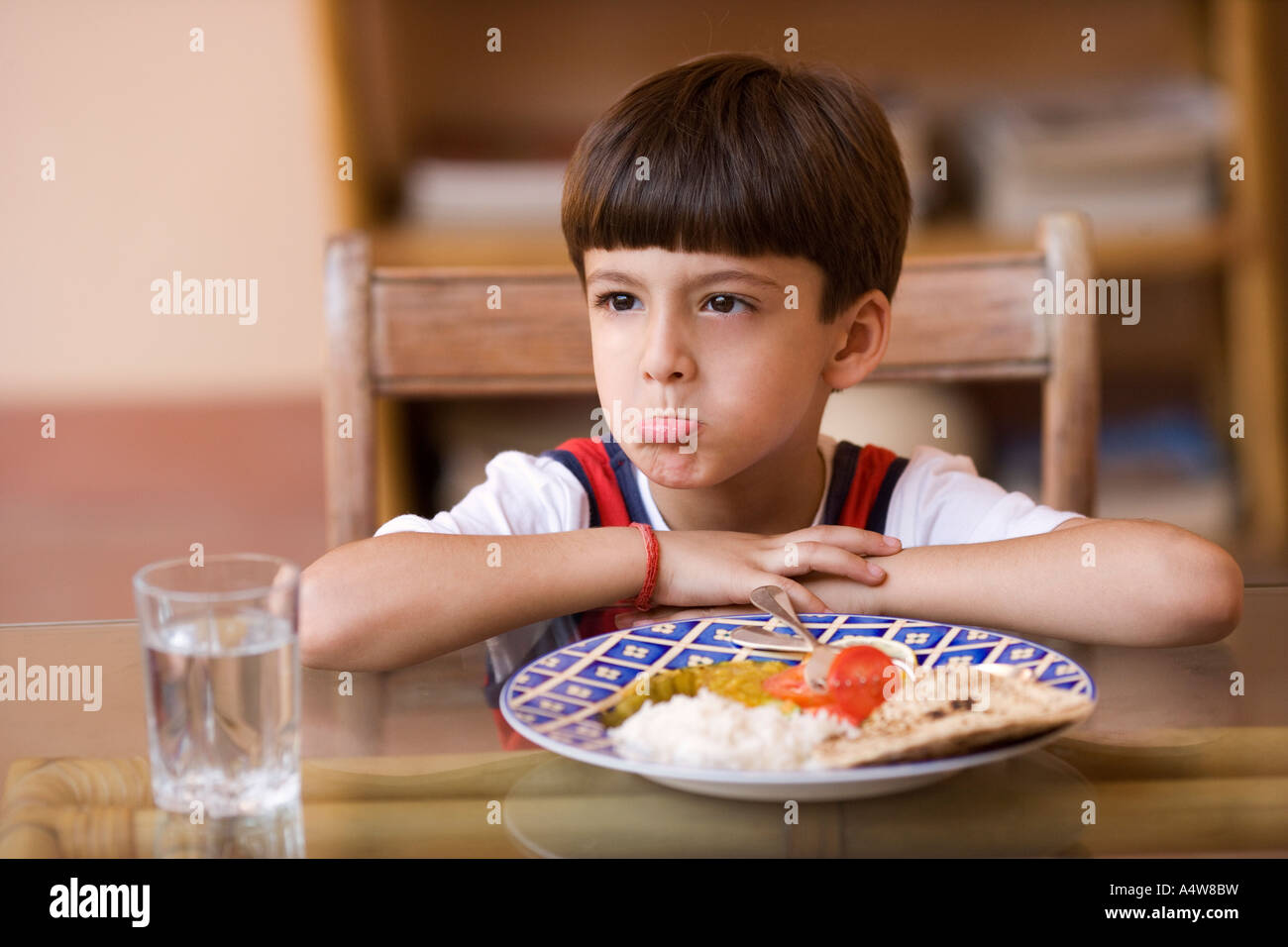 Young boy refusing to eat Stock Photo - Alamy