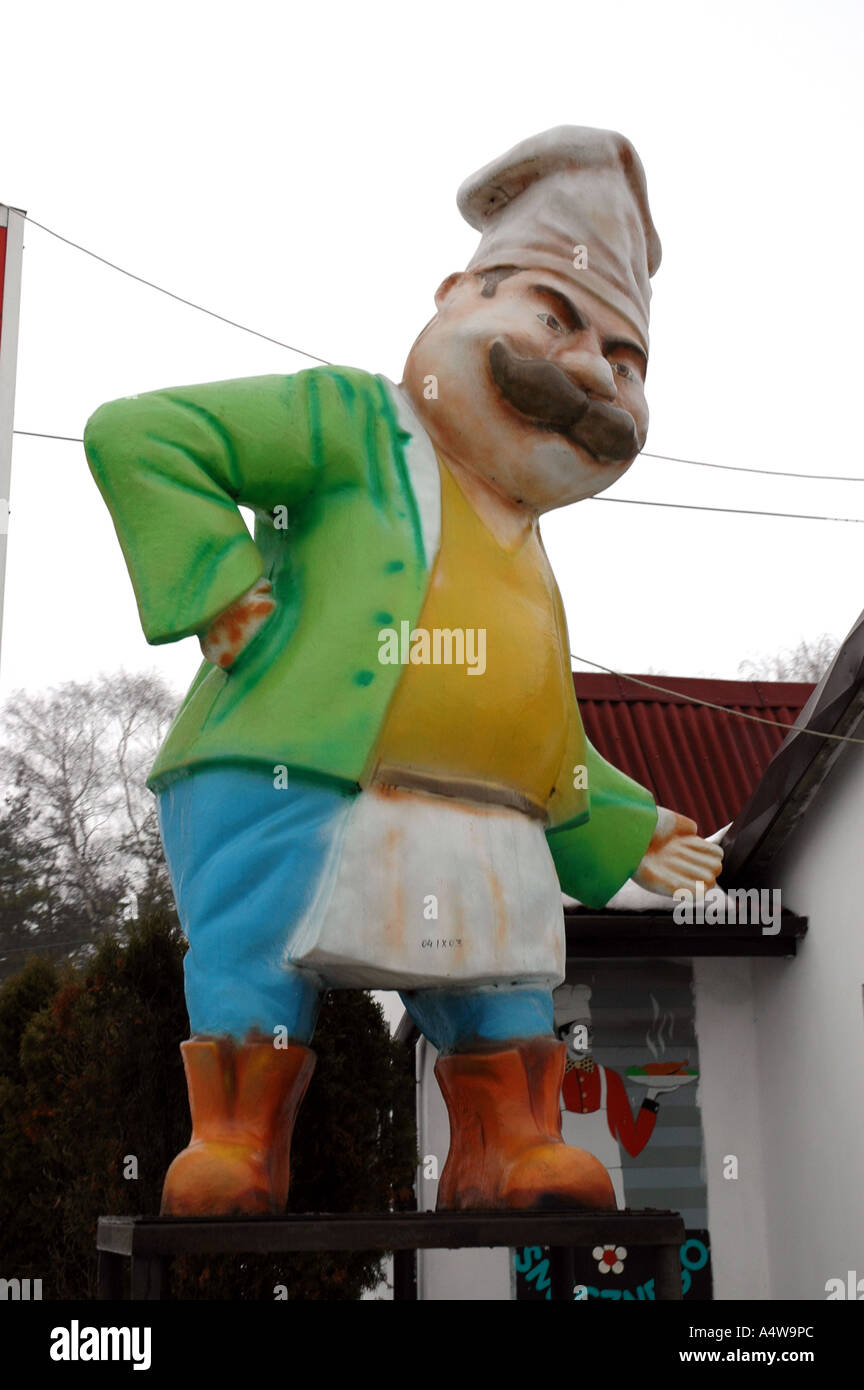 Cook figure motioning in to restaurant Stock Photo - Alamy