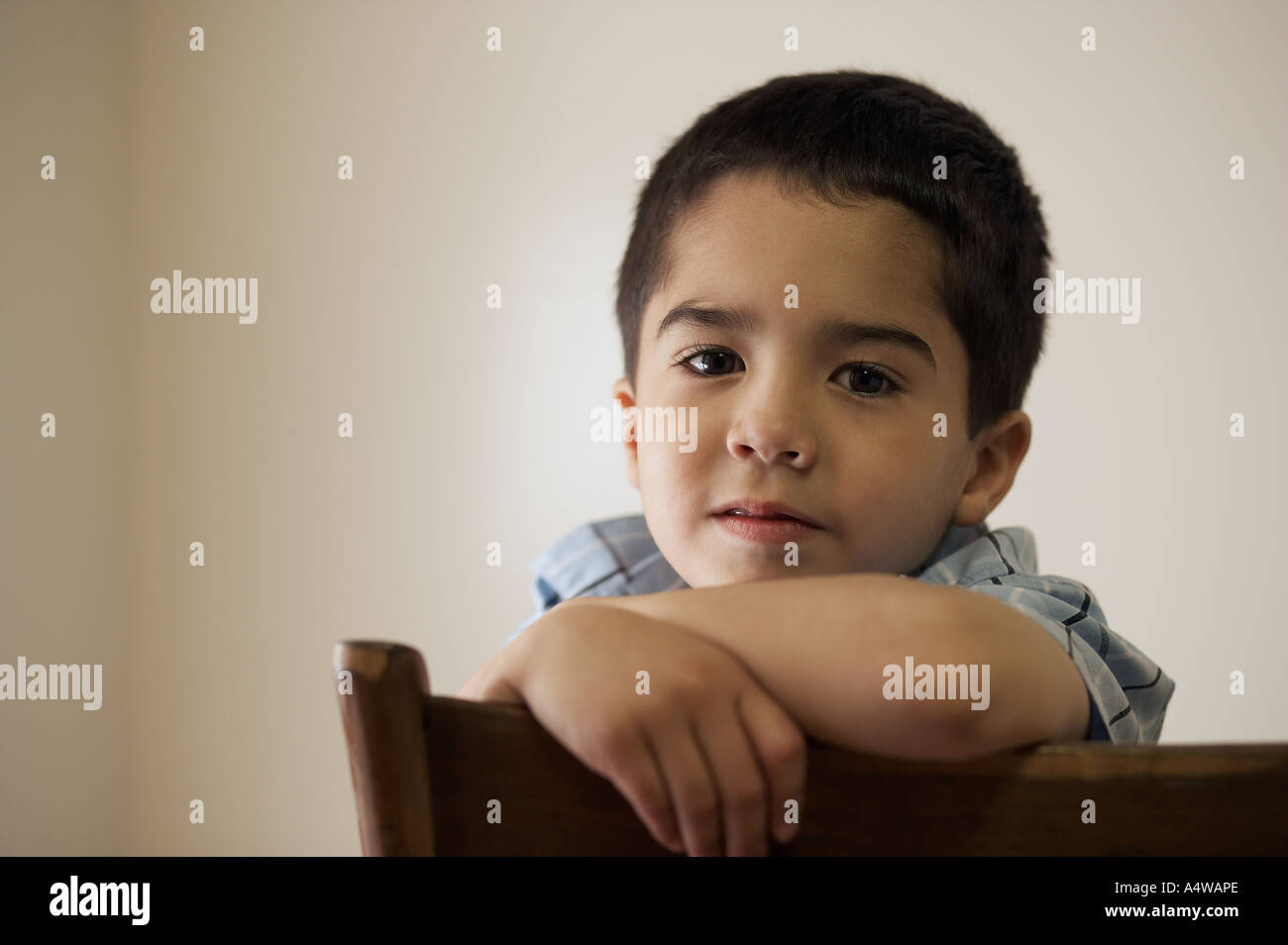 Portrait of young boy leaning over chair Stock Photo - Alamy Portrait of young boy leaning over chair Stock Photo - Alamy