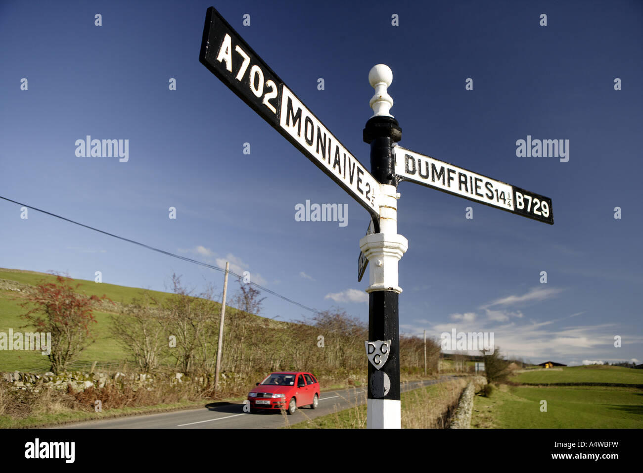 Old style road sign on a rural road the A702 Moniaive Thornhill road ...