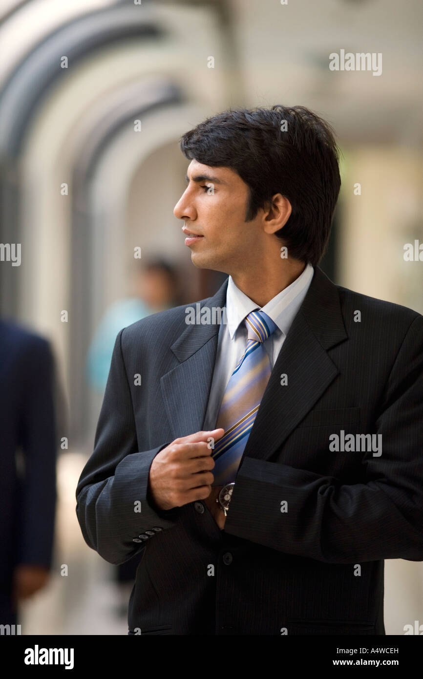 Businessman reaching into suit Stock Photo - Alamy