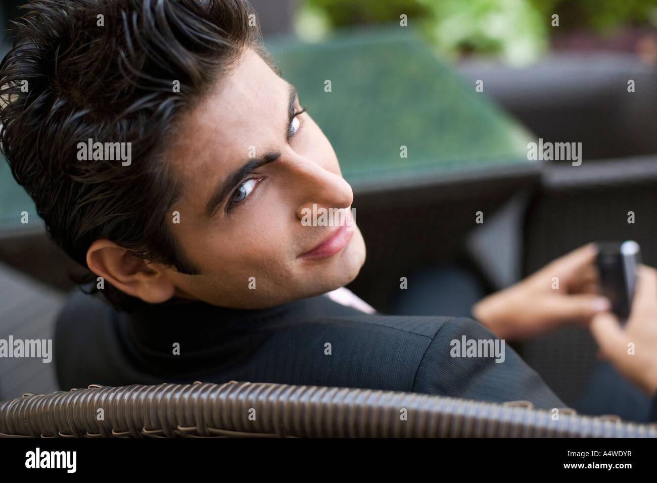 Businessman looking over shoulder Stock Photo - Alamy