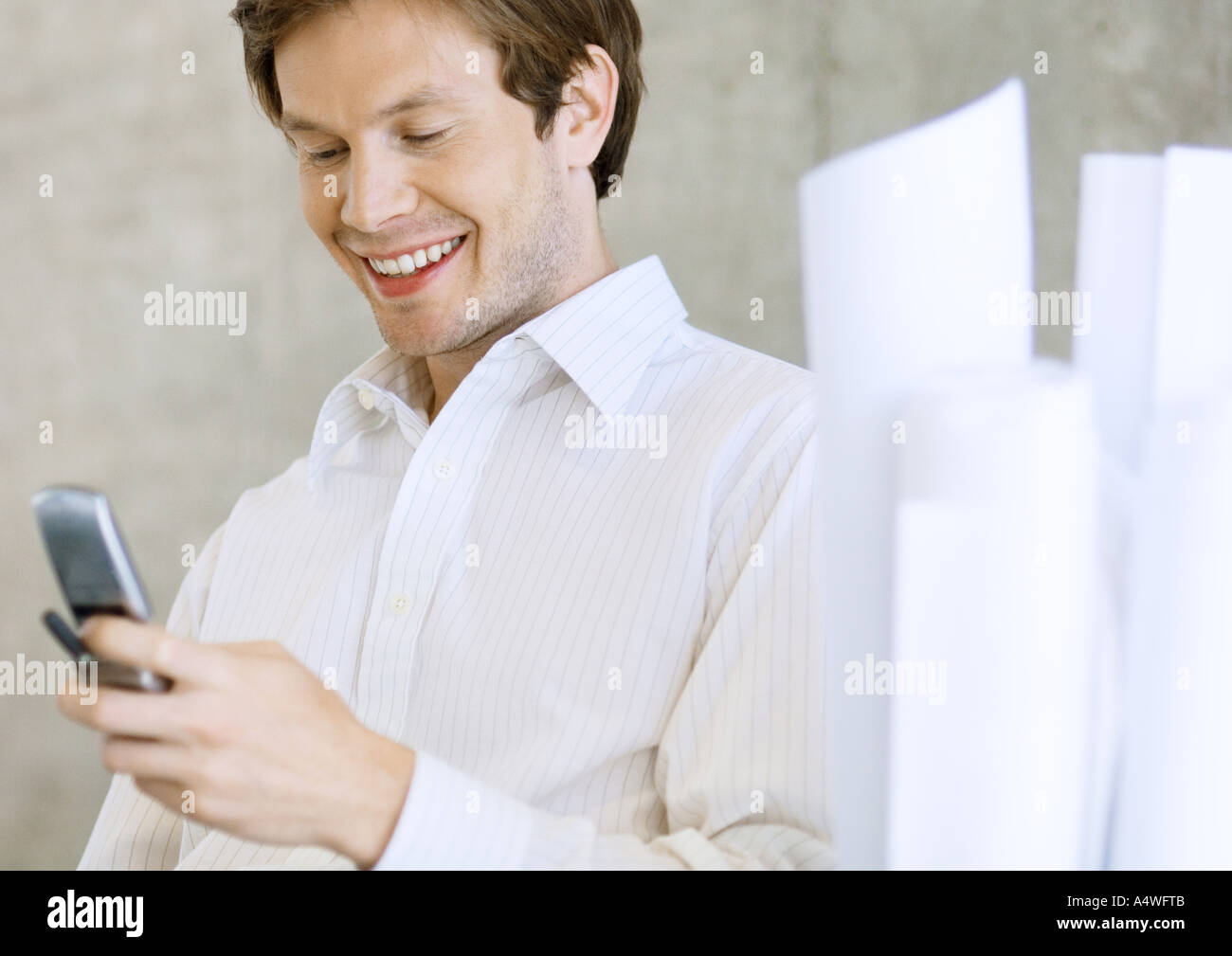 Architect holding cell phone, smiling Stock Photo - Alamy Architect holding cell phone, smiling Stock Photo - Alamy