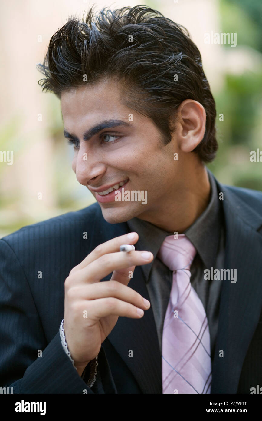 East indian man smoking hi-res stock photography and images - Alamy