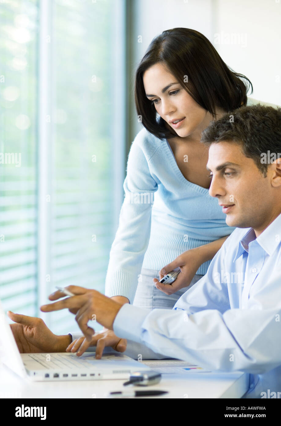 Woman and man working on laptop together Stock Photo - Alamy