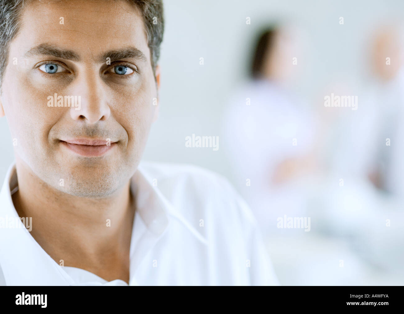 Man wearing white shirt with open collar, portrait Stock Photo - Alamy