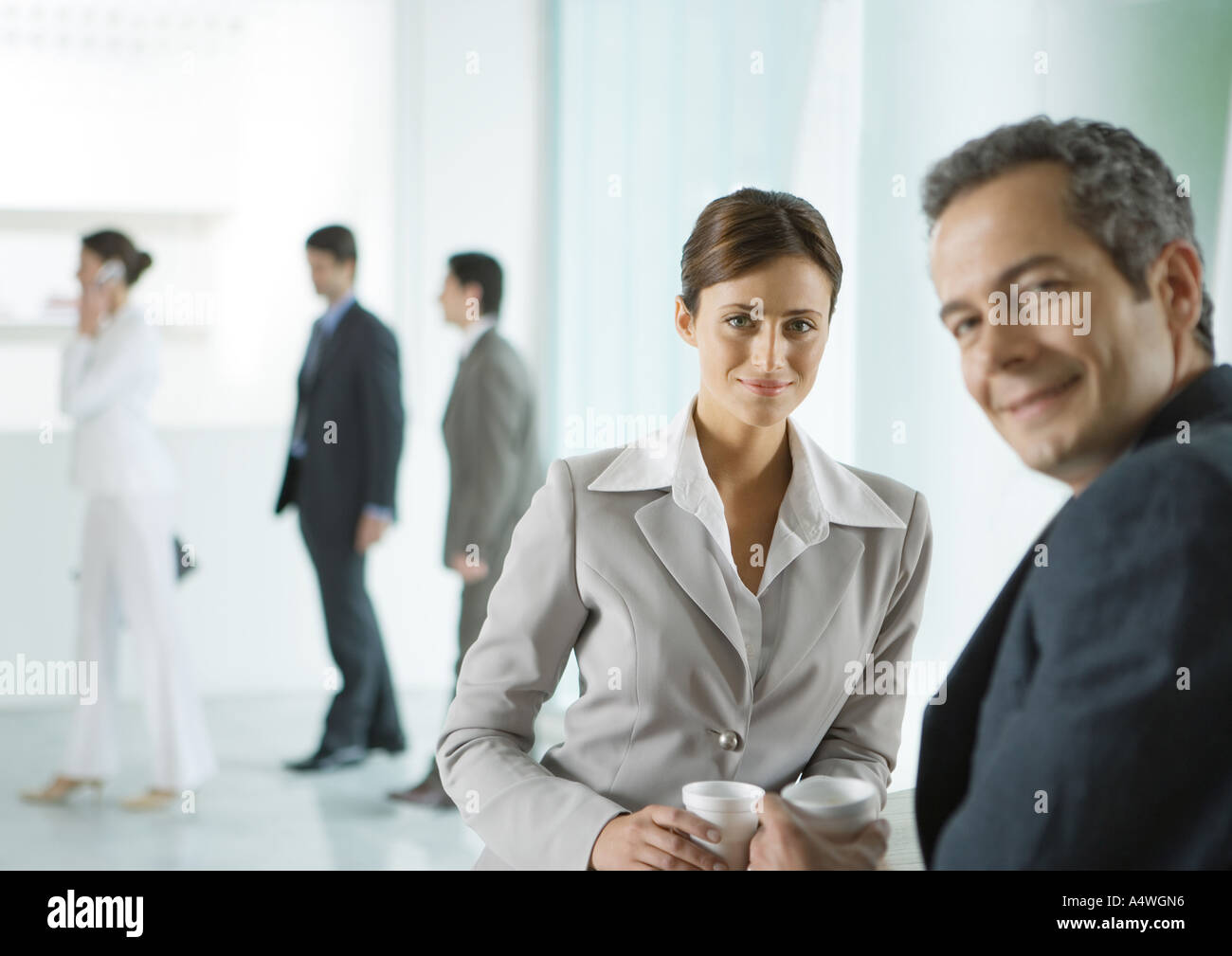 Business colleagues having coffee break in lobby Stock Photo - Alamy