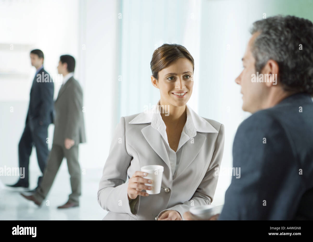 Business colleagues having coffee break in lobby Stock Photo - Alamy