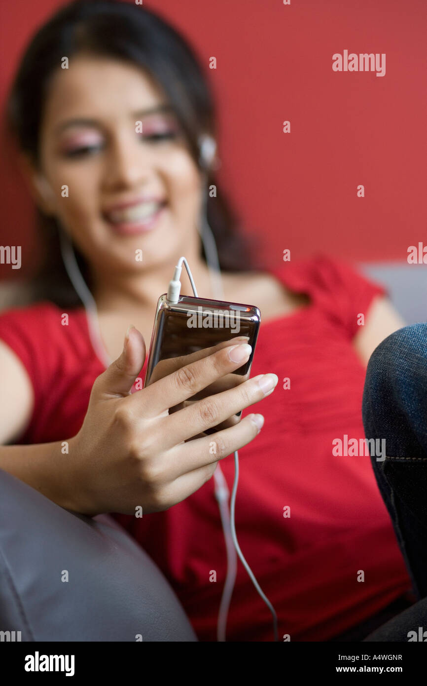 Woman listening to mp3 player Stock Photo - Alamy