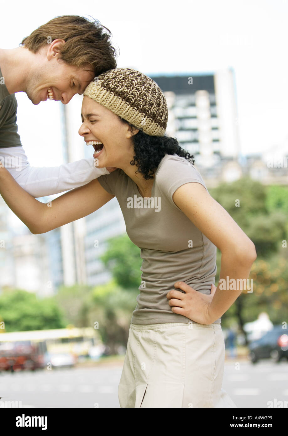 Young couple laughing Stock Photo - Alamy