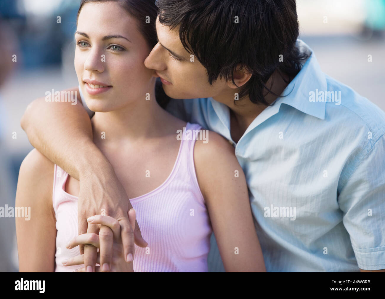 Young couple, man leaning over woman's shoulder Stock Photo - Alamy