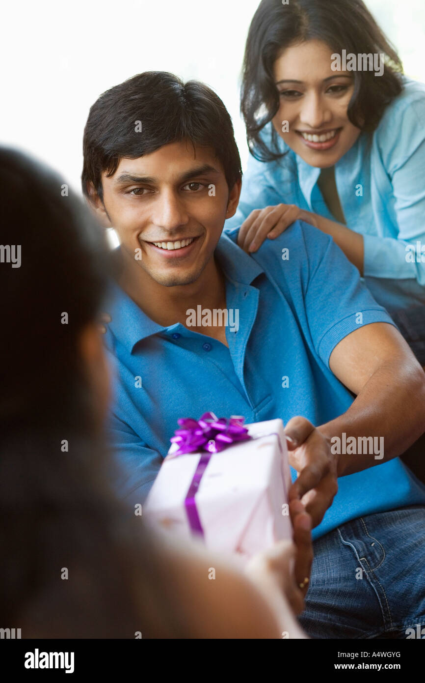 Friends exchanging gifts Stock Photo - Alamy