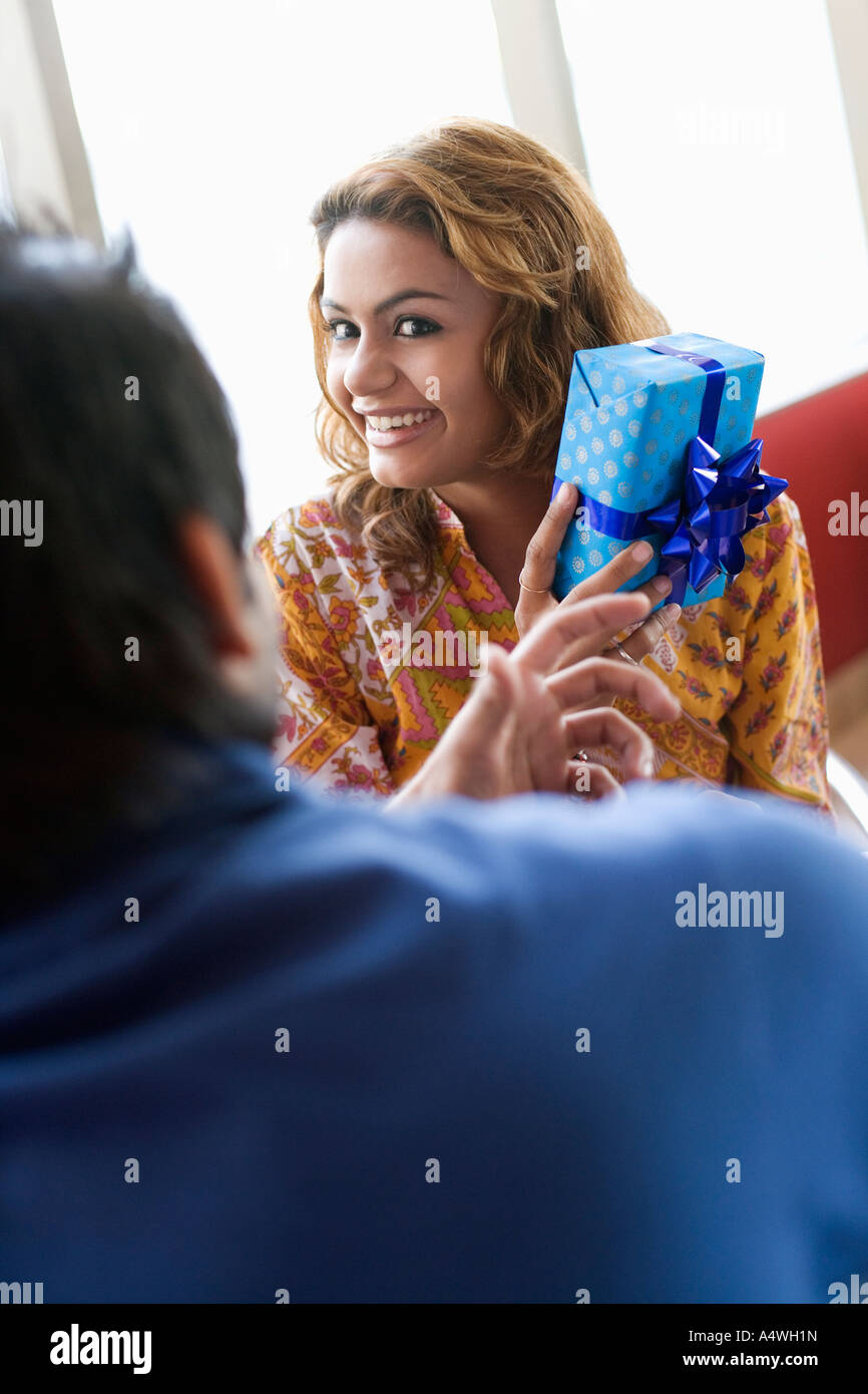Woman shaking gift Stock Photo - Alamy