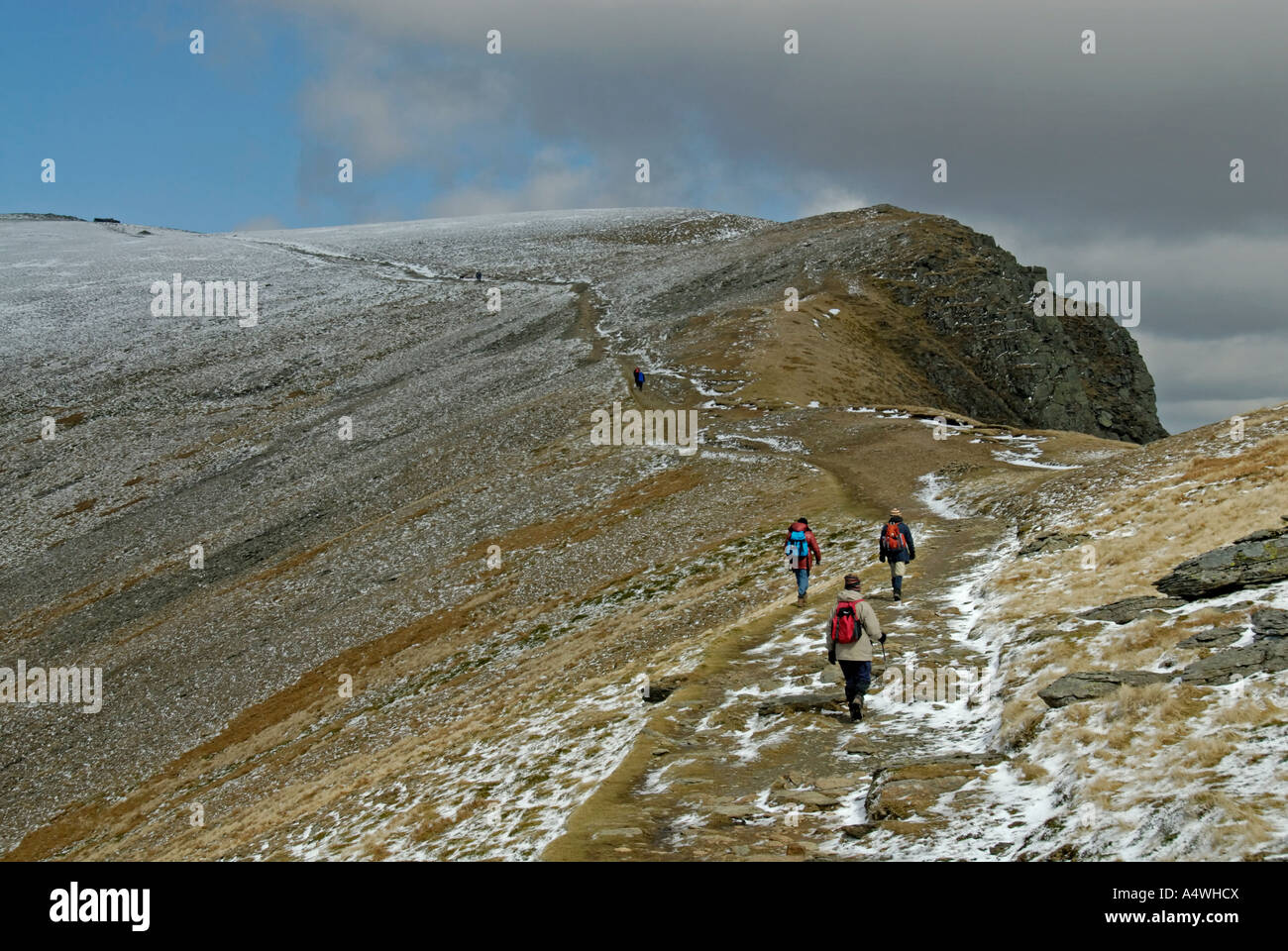 Walkers approaching the summit of Helvellyn in Winter. Lake District ...