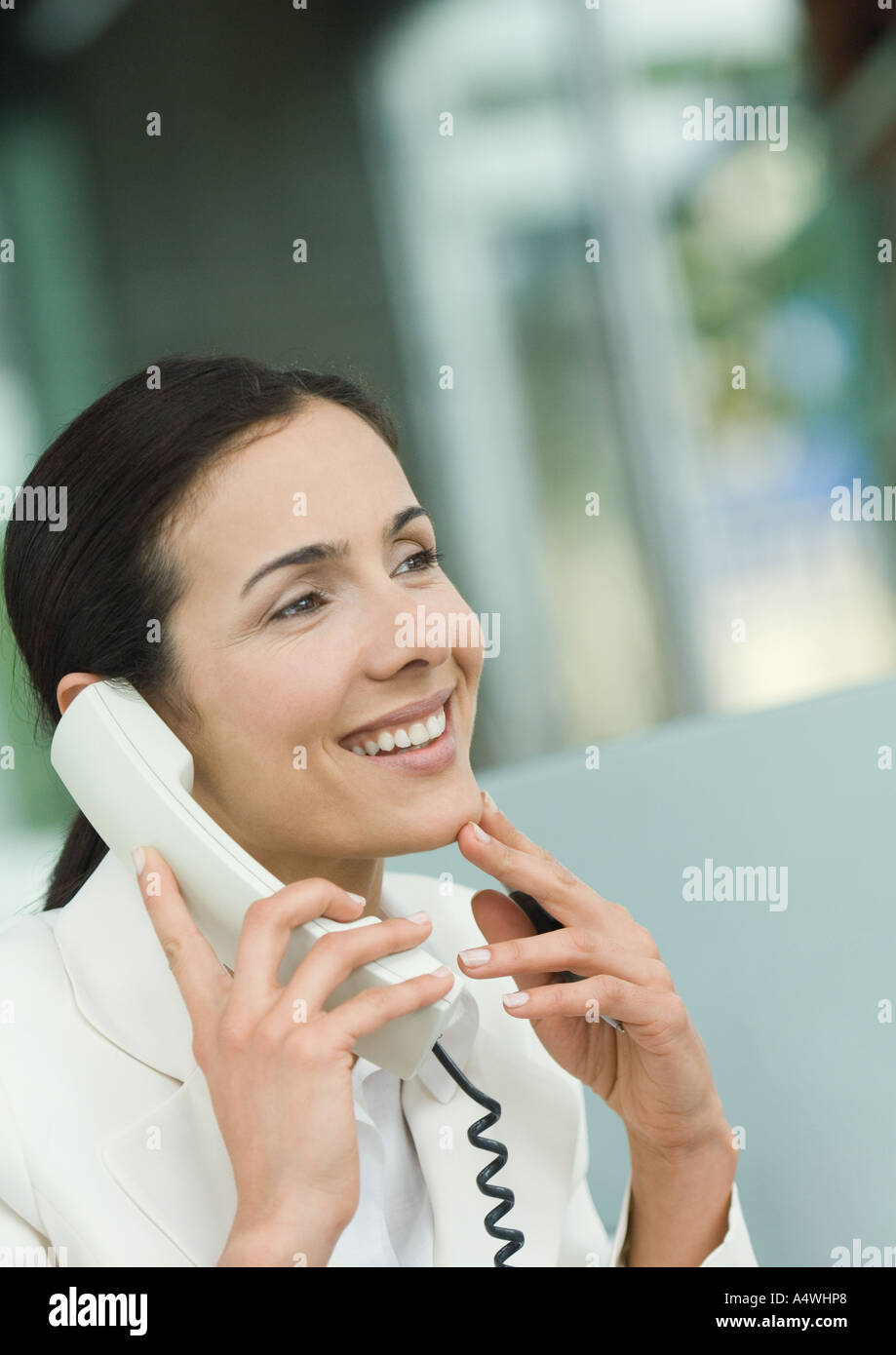 Phone under chin while using hands hi-res stock photography and images ...