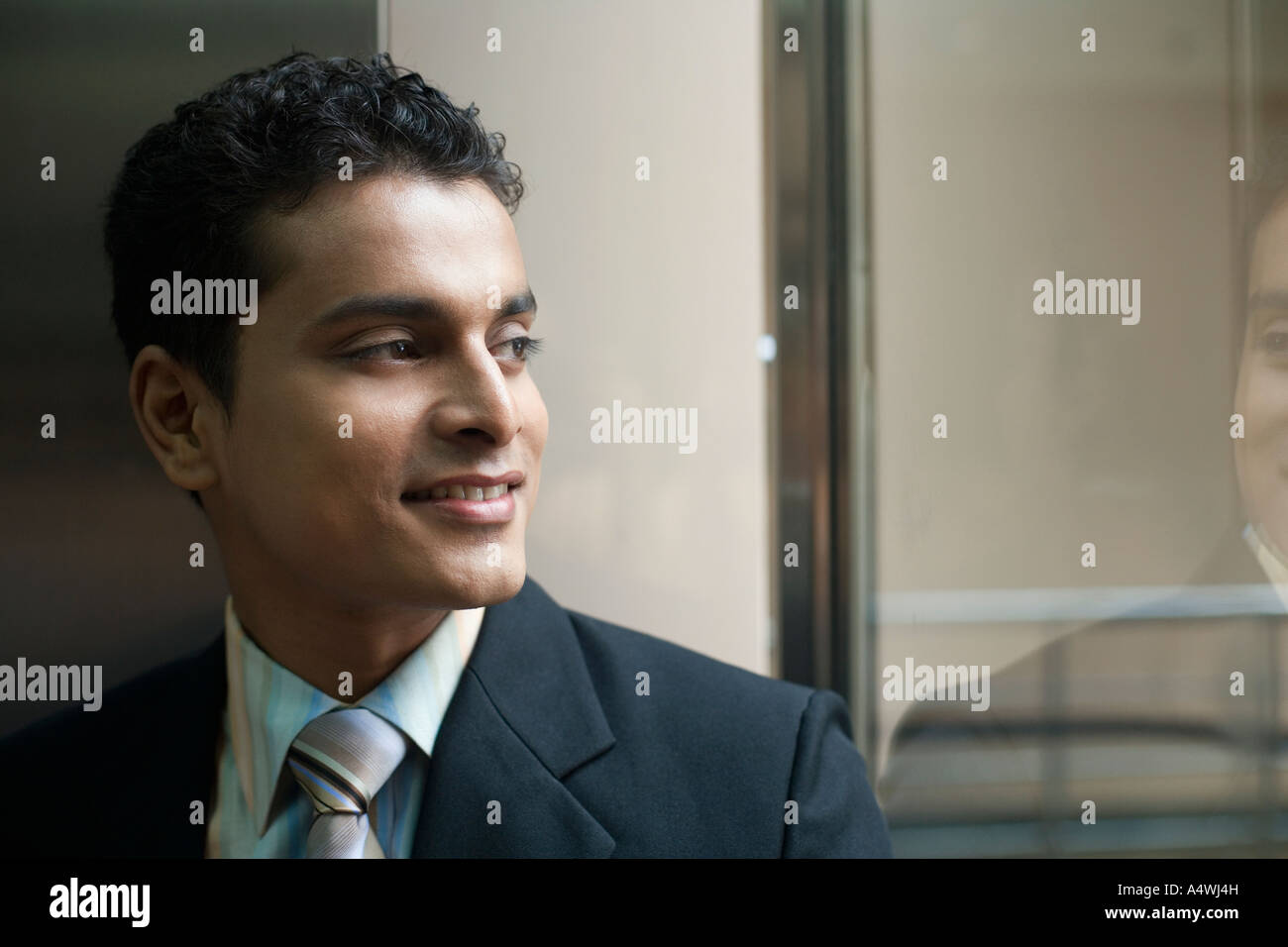 Businessman looking out window Stock Photo - Alamy