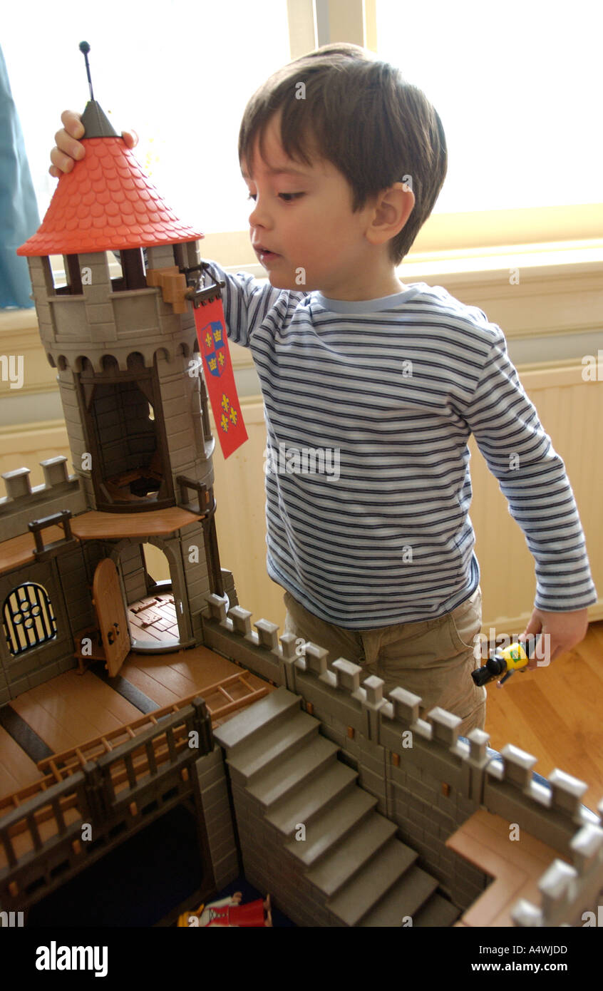 Little boy plays with a toy castle Stock Photo - Alamy