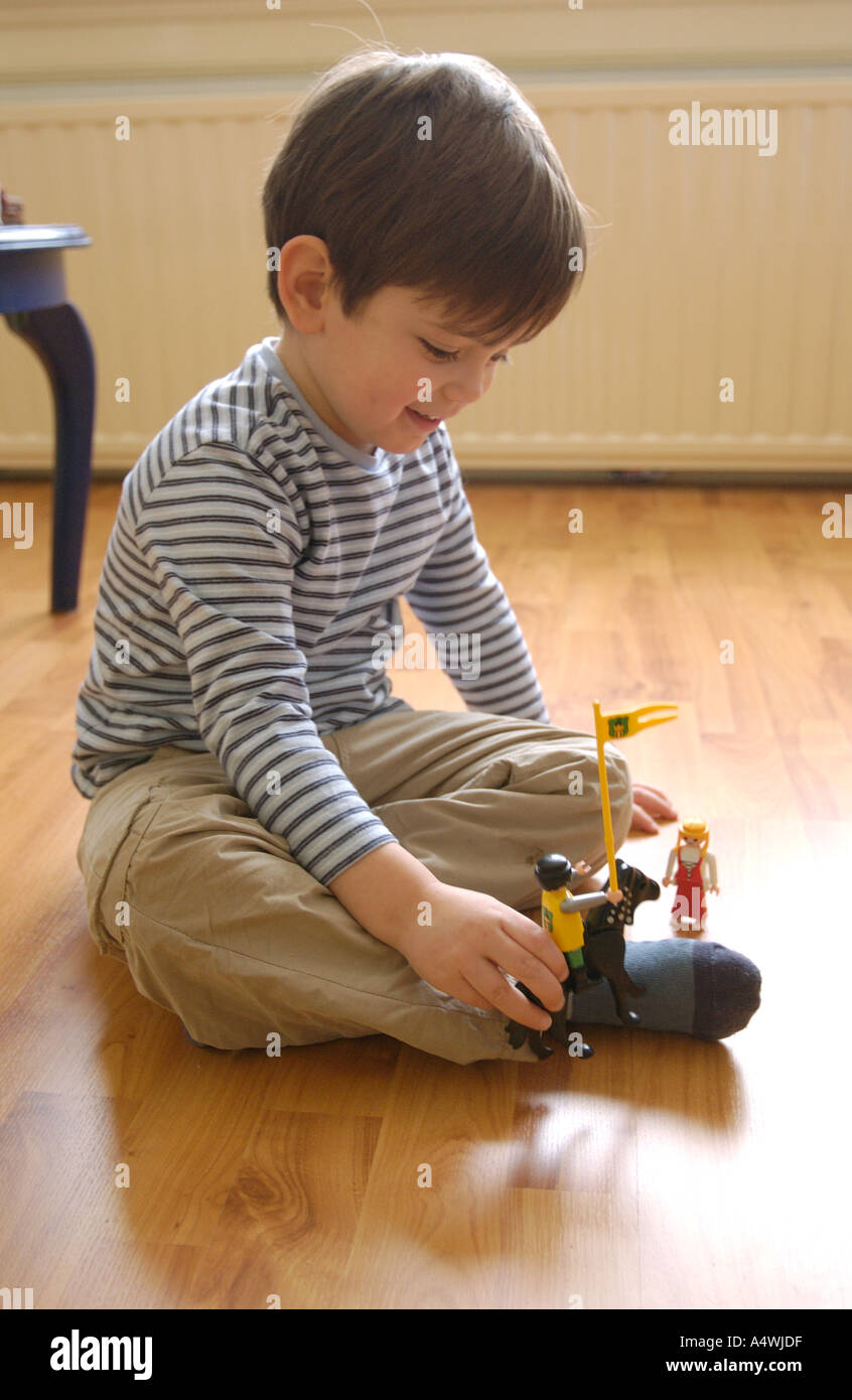 Little boy playing with knights Stock Photo - Alamy