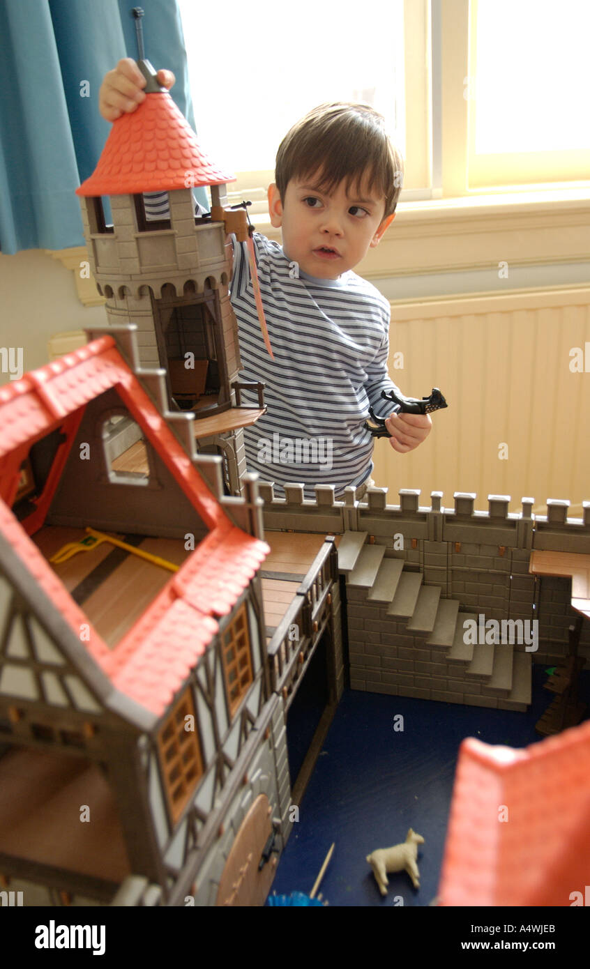 Little boy plays with a toy castle Stock Photo - Alamy