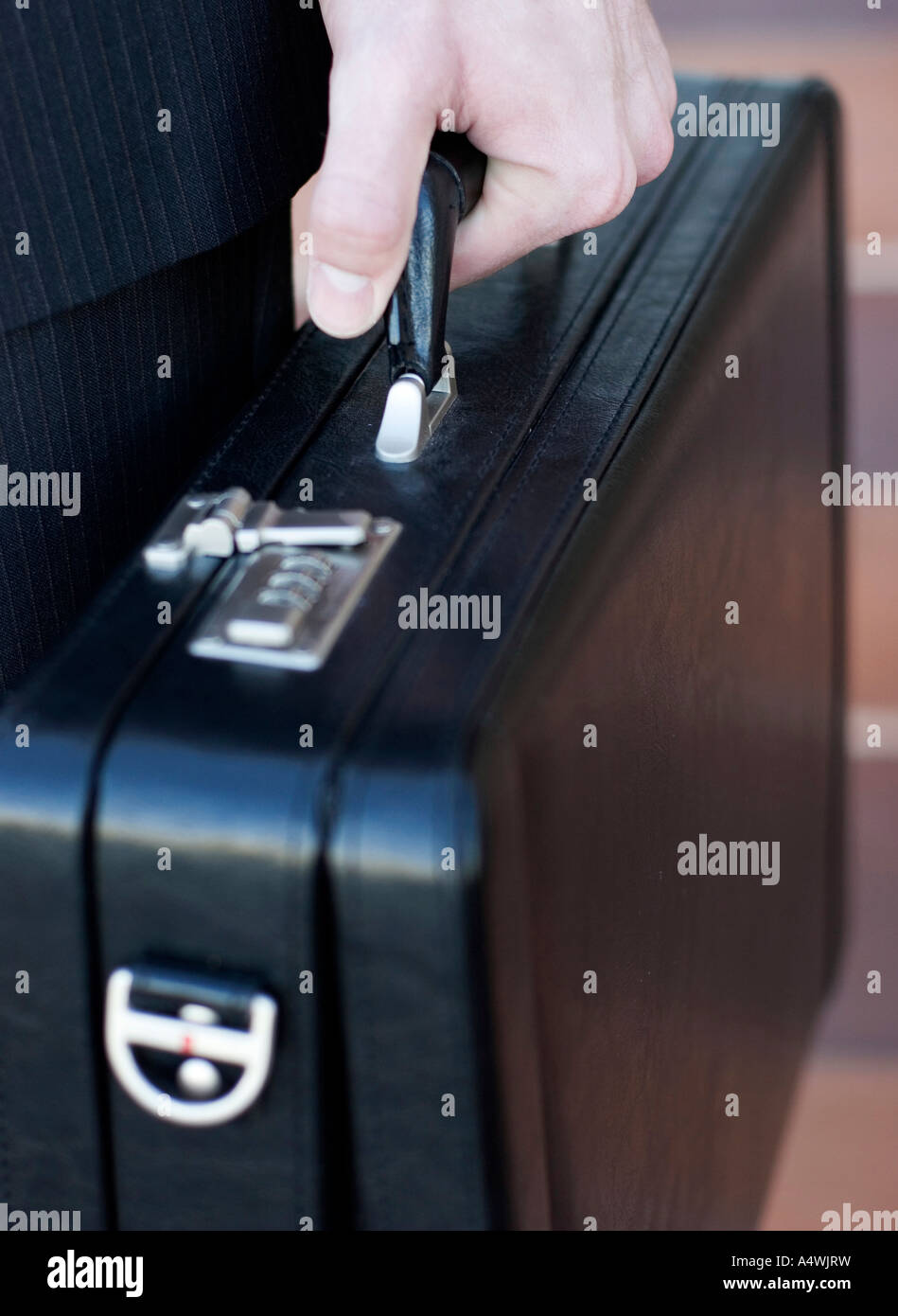 Businessman holding his briefcase in his hand Stock Photo - Alamy