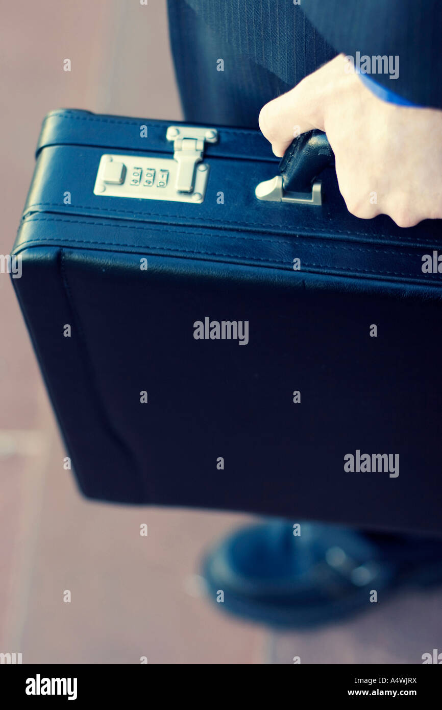 Businessman Holding Briefcase in his hand facing to the right wearing a ...