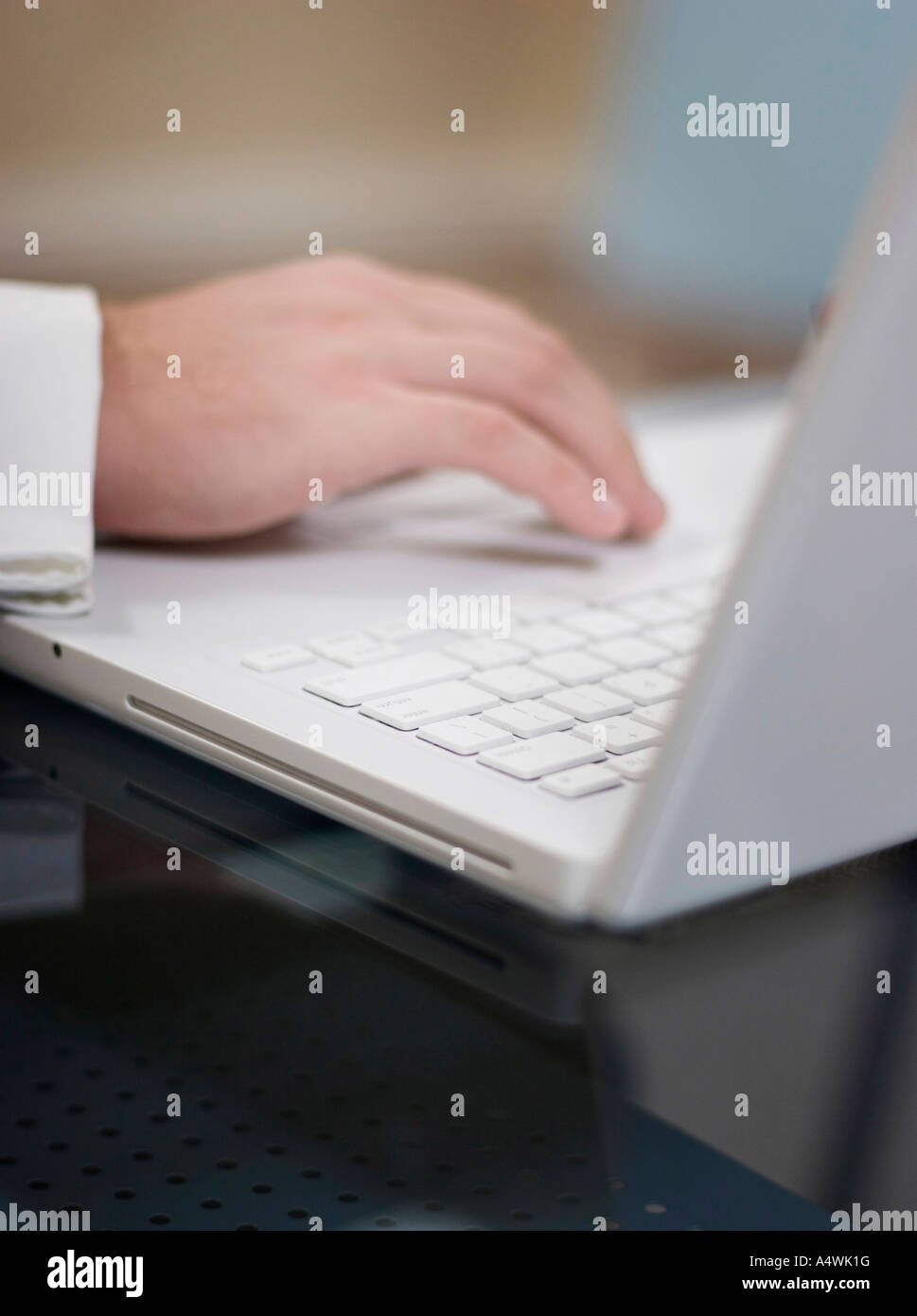 Businessman uses laptop with his hand as he works Stock Photo - Alamy