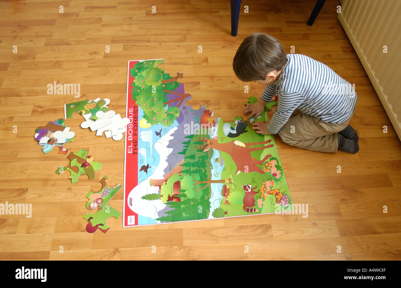 Little boy is making a puzzle Stock Photo - Alamy