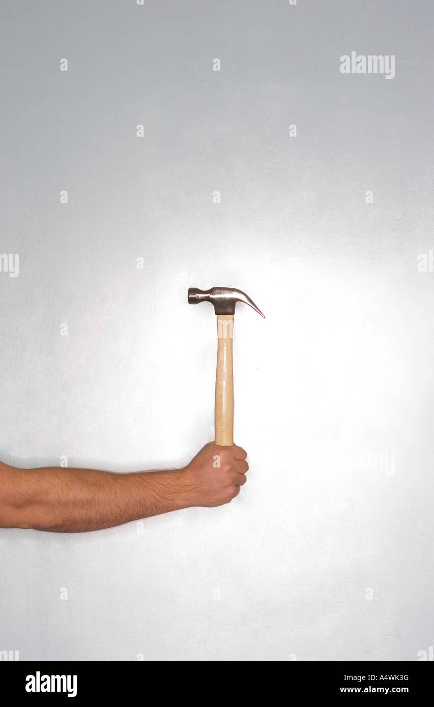 Man holding a hammer sticking his hand out into the middle of the ...
