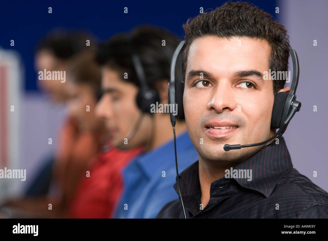 Businessman wearing a headset while working Stock Photo - Alamy