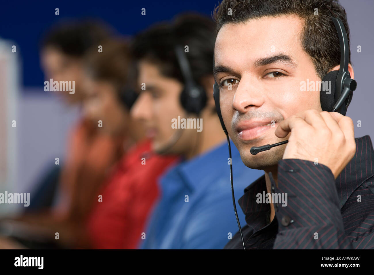 Businessman wearing a headset while working Stock Photo - Alamy