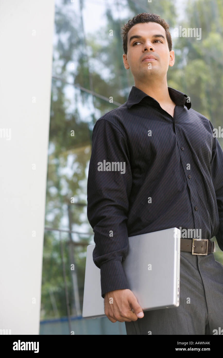 Businessman carrying laptop Stock Photo - Alamy