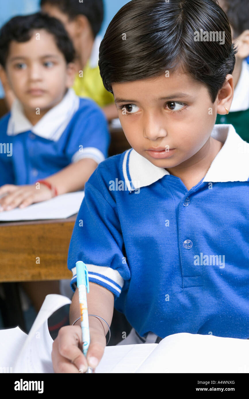 Young girl writing in classroom Stock Photo - Alamy