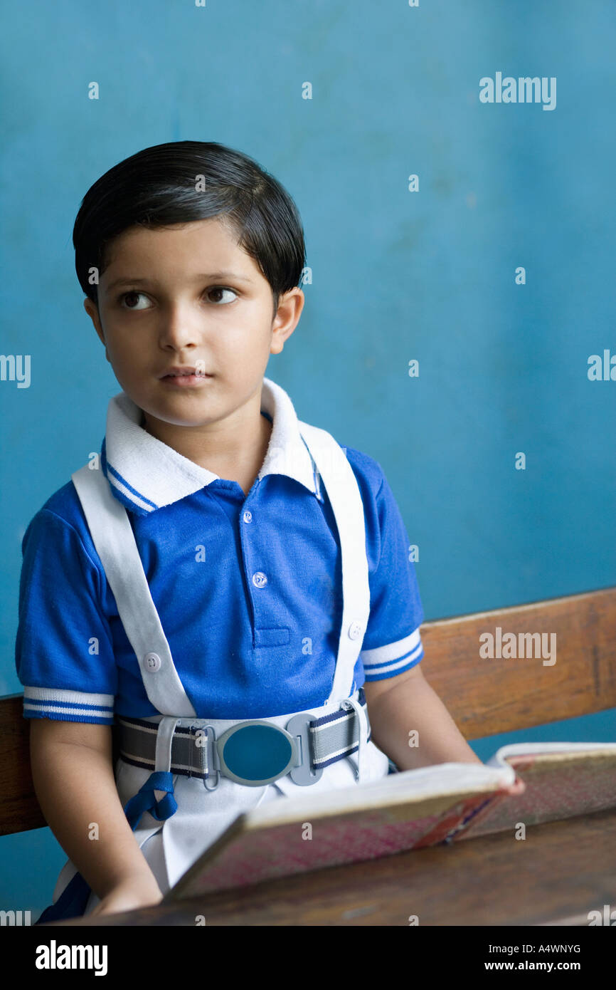 Young boy sitting in classroom Stock Photo - Alamy