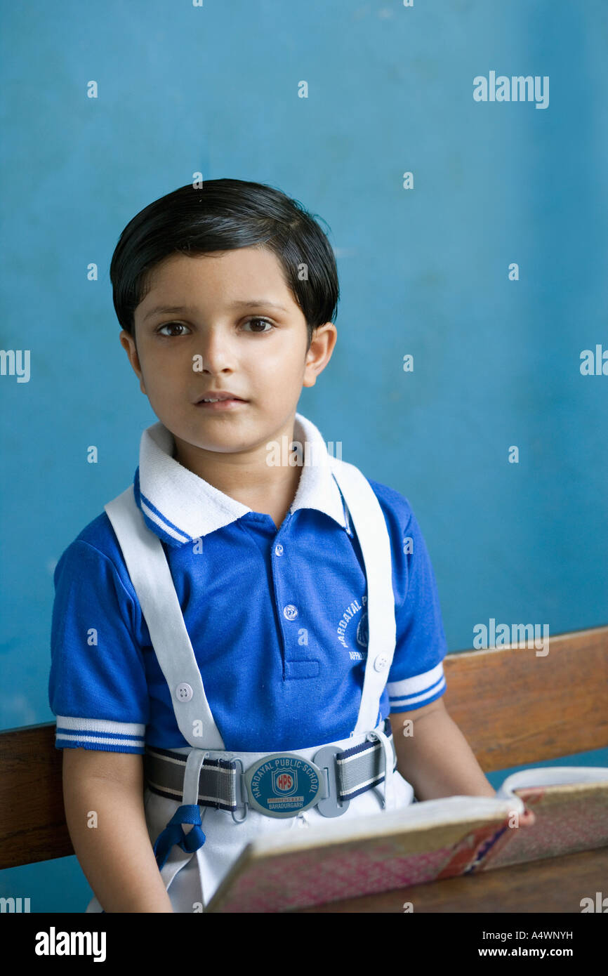 Young boy reading in classroom Stock Photo - Alamy