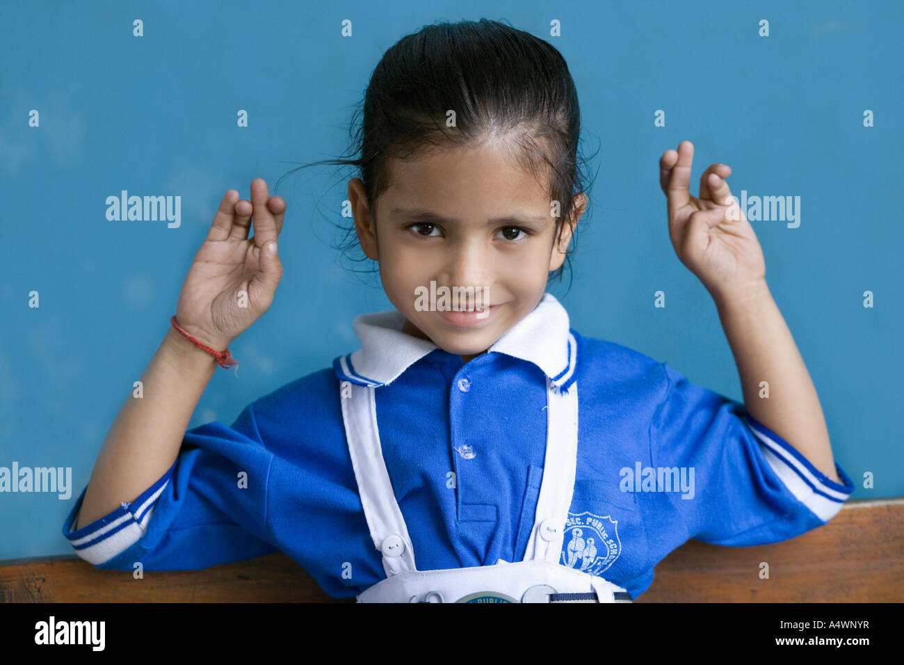 Young girl crossing fingers Stock Photo - Alamy