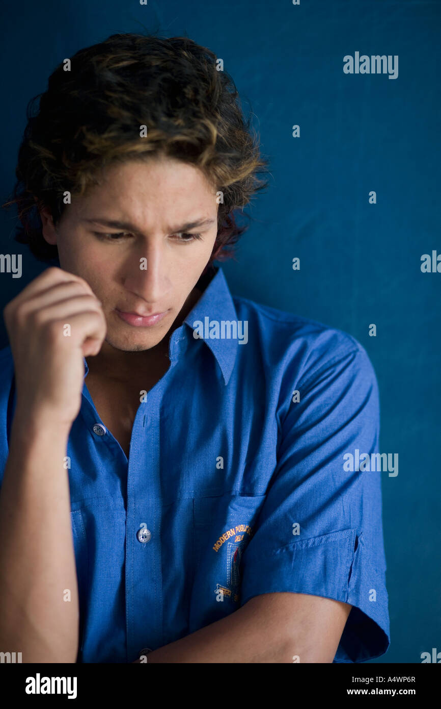 Teenage boy thinking in front of blackboard Stock Photo - Alamy