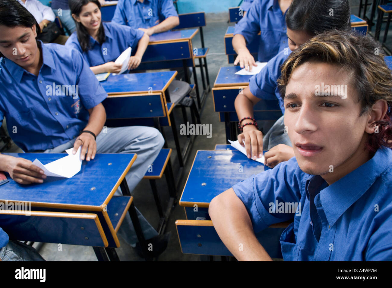 Students making paper airplanes in classroom Stock Photo - Alamy