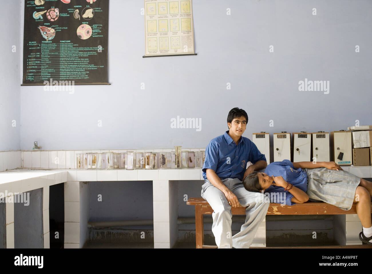Students on bench in classroom Stock Photo - Alamy