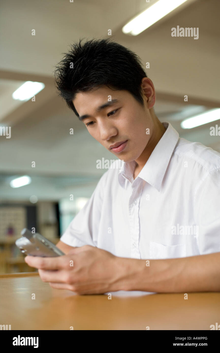 Male student using his cell phone Stock Photo - Alamy