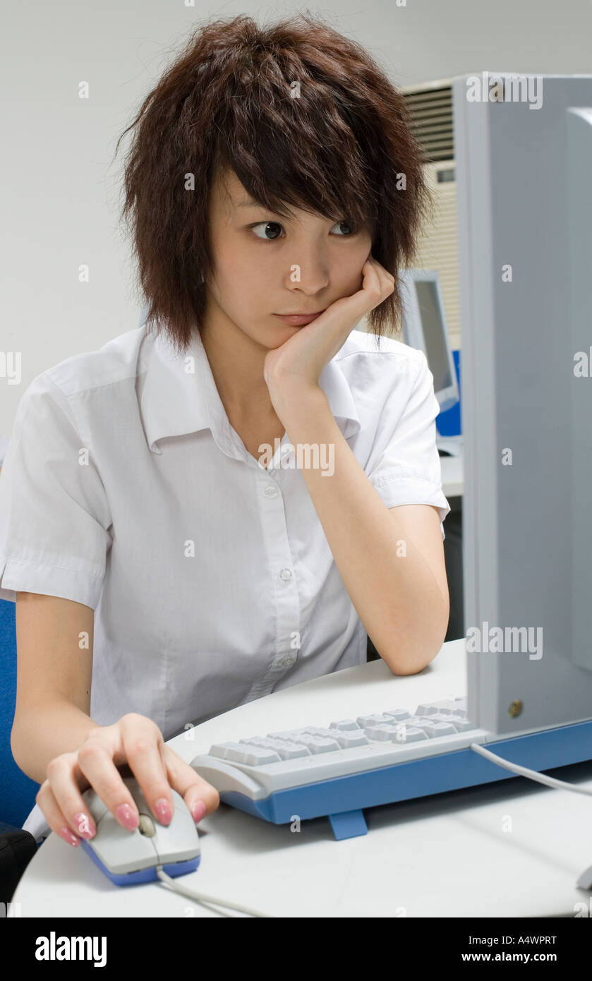 Female student working at a computer Stock Photo - Alamy