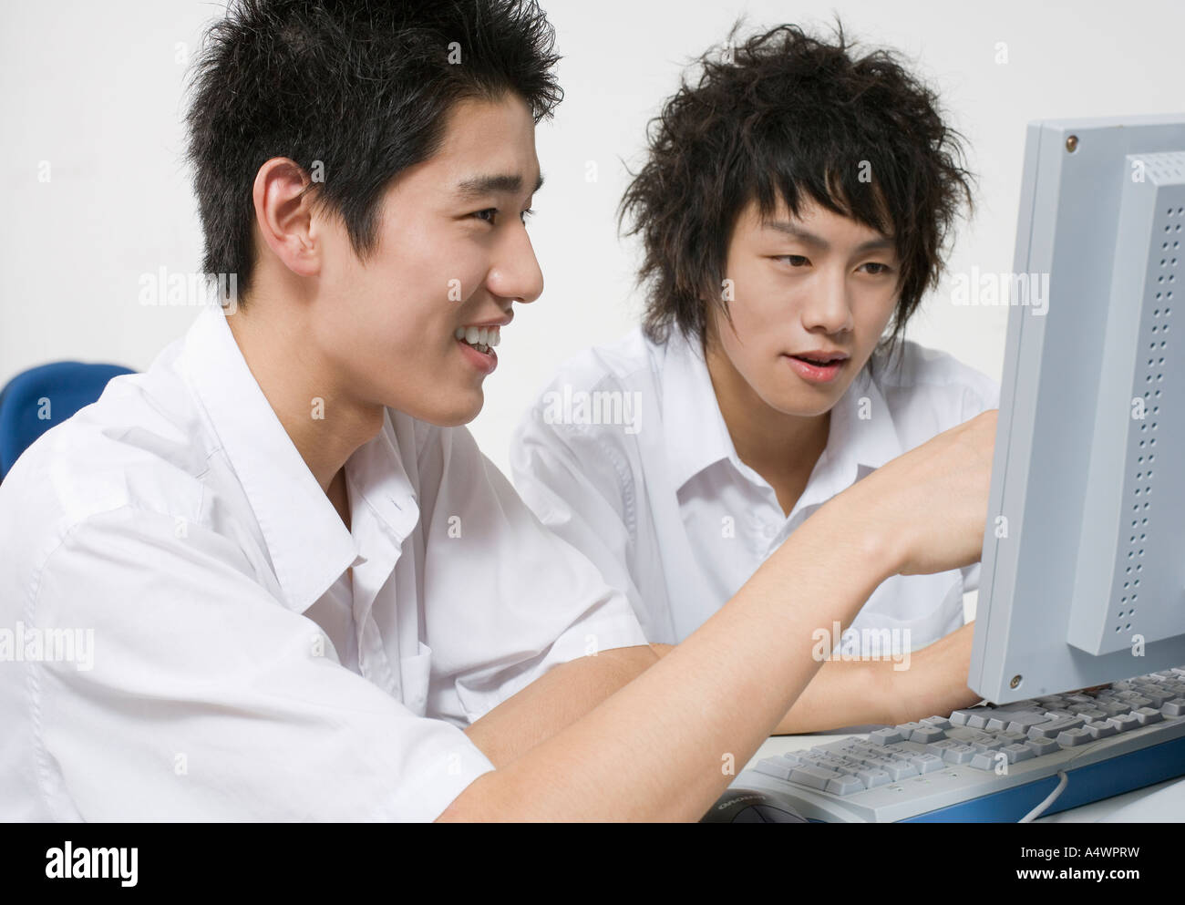 Male students working at a computer Stock Photo - Alamy