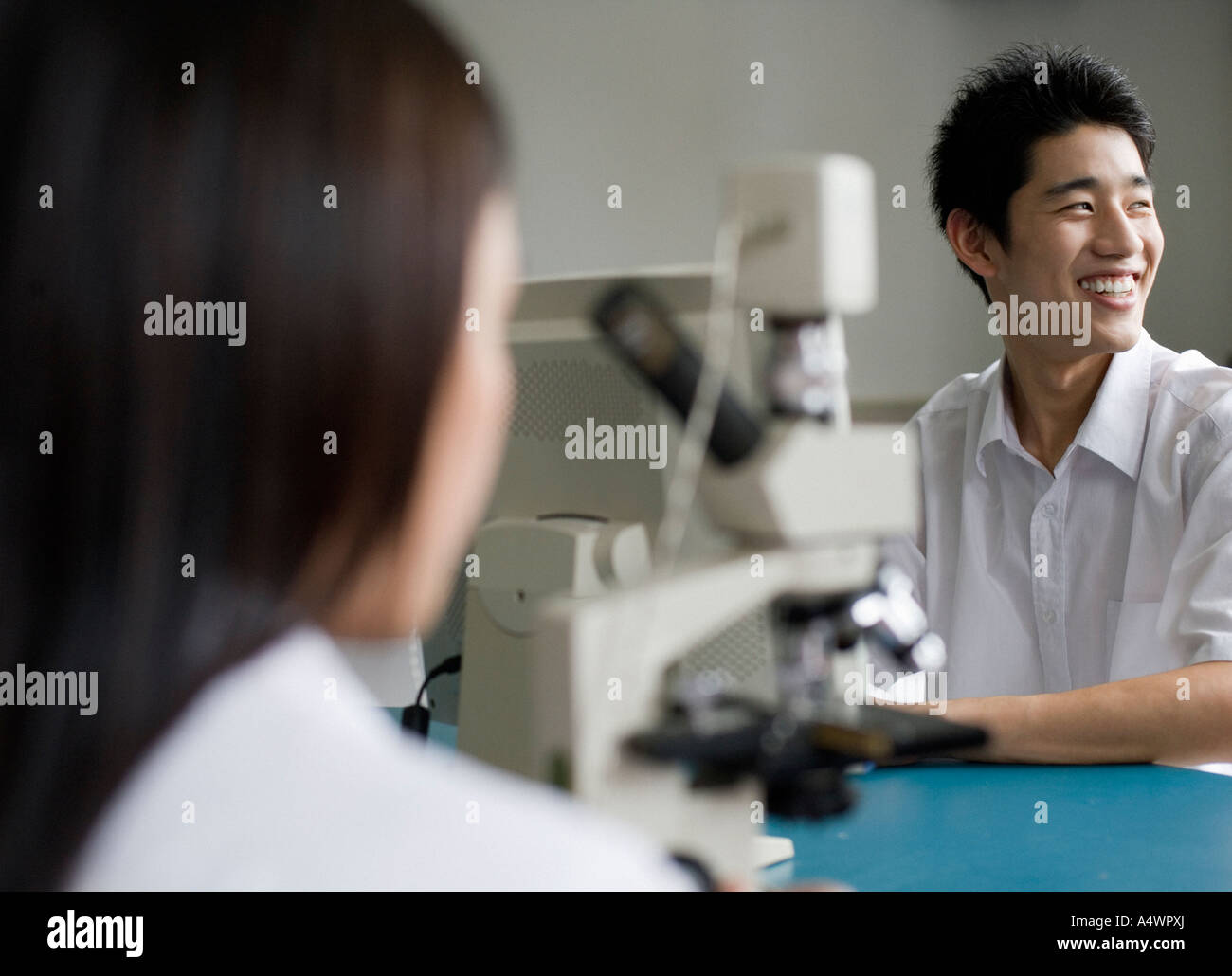 Male student laughing at a computer Stock Photo - Alamy