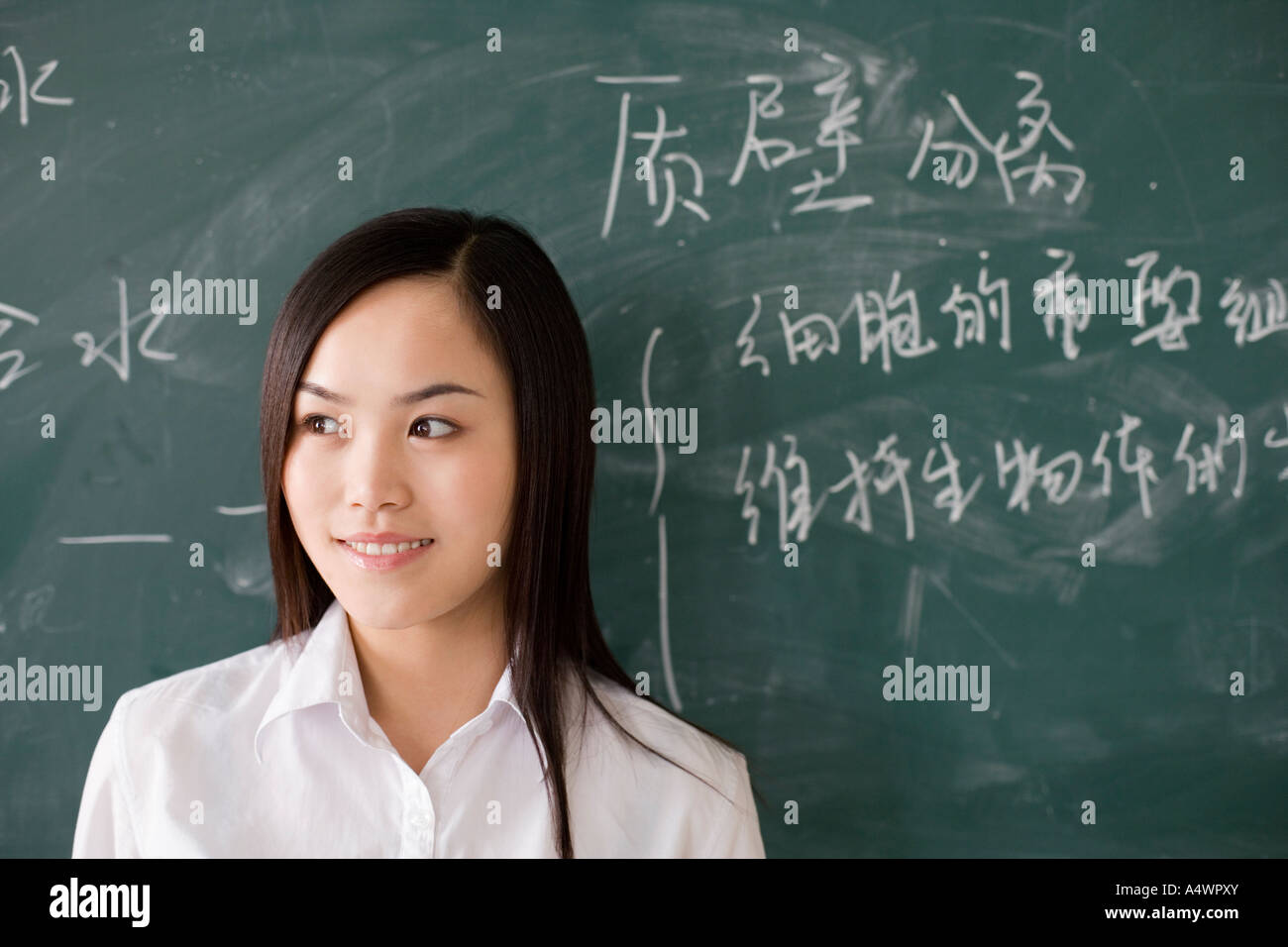 Female student standing at the blackboard Stock Photo - Alamy